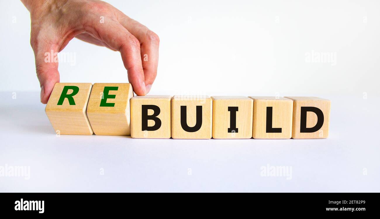 Time to rebuild symbol. Businessman turns wooden cubes and changes the ...