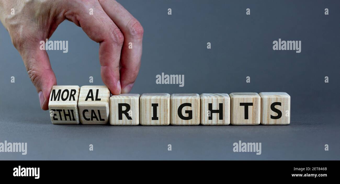 Ethical or moral rights symbol. Businessman turns wooden cubes and ...
