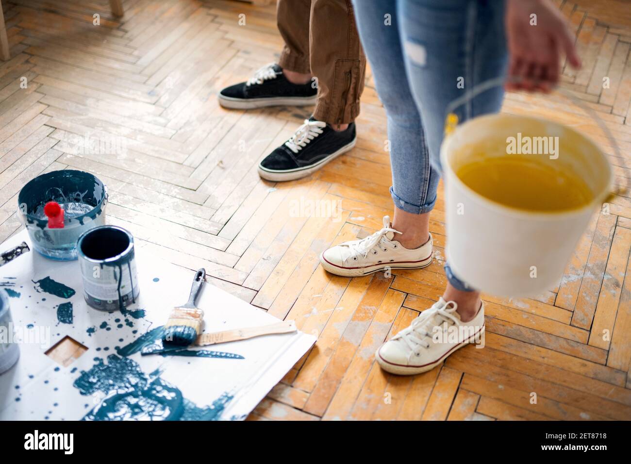 Unrecognizable couple painting wall indoors at home, relocation and diy ...