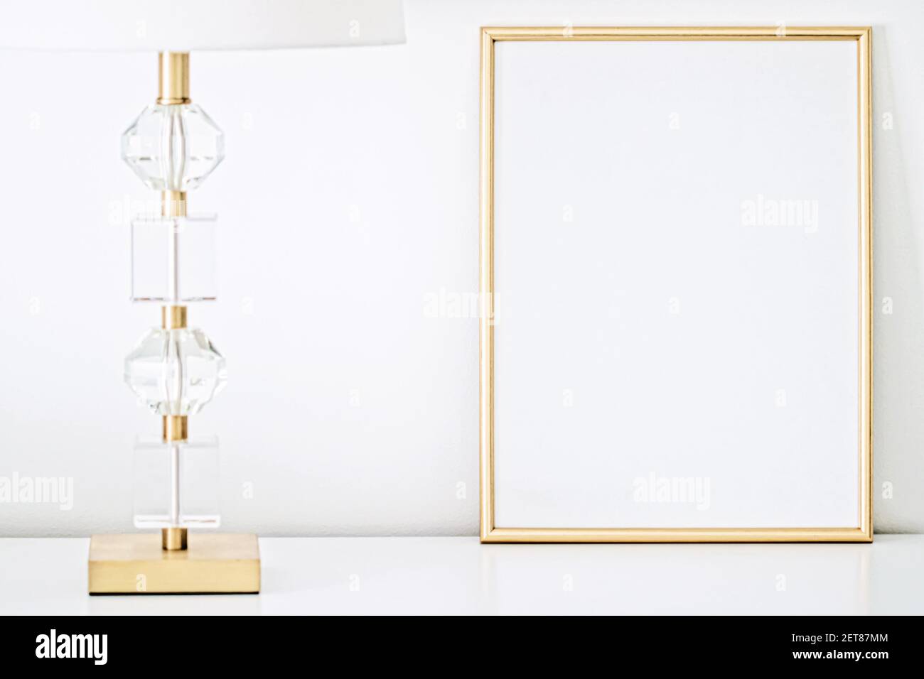 Golden frame for art, poster or photo in white interior, home decor ...