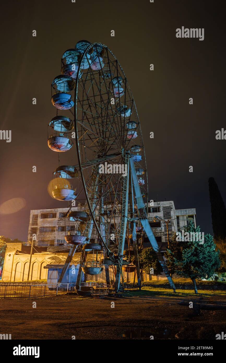 Old rusty broken abandoned Ferris wheel at night Stock Photo - Alamy