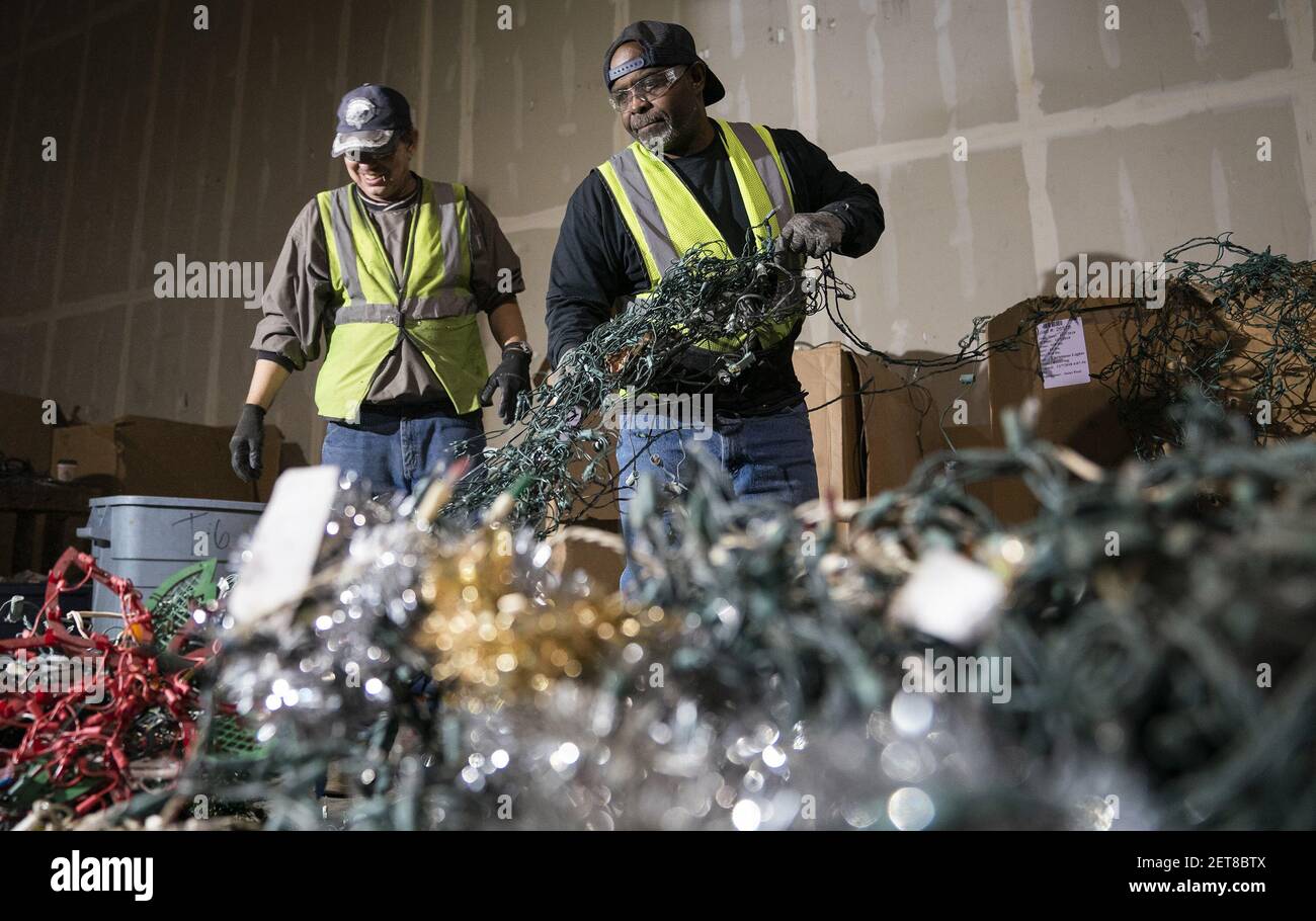 Jerry Schneider, left, and Pervis Harris sort through holiday lights at ...