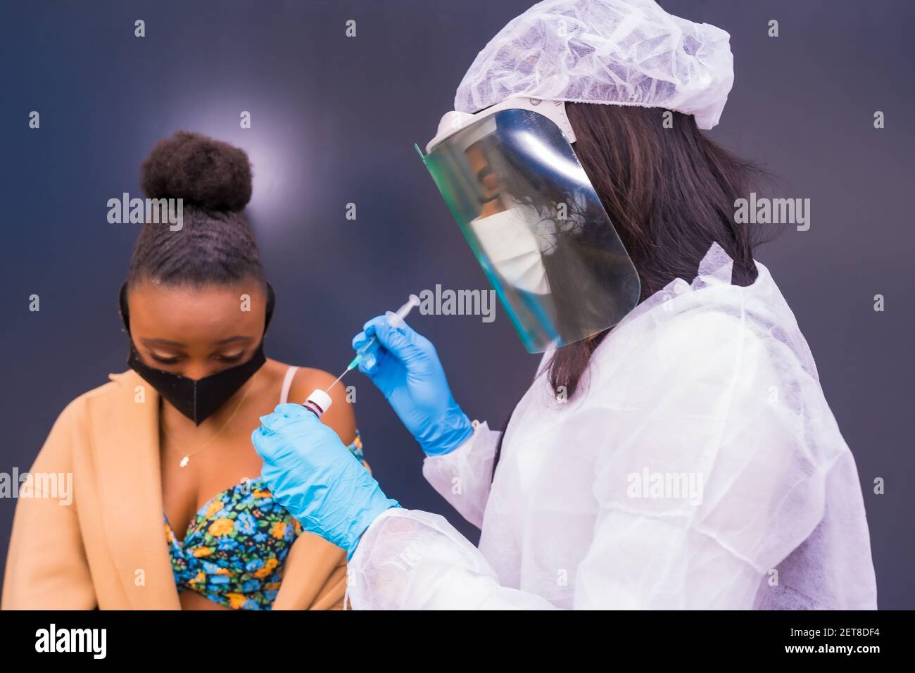 African nurse injecting senior woman hi-res stock photography and ...