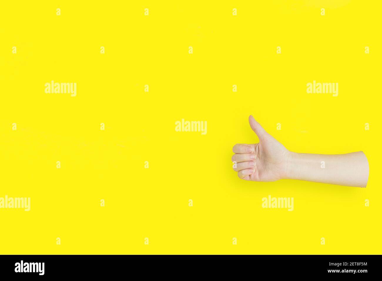 Hand sign thumbs up with copy space on yellow background Stock Photo ...