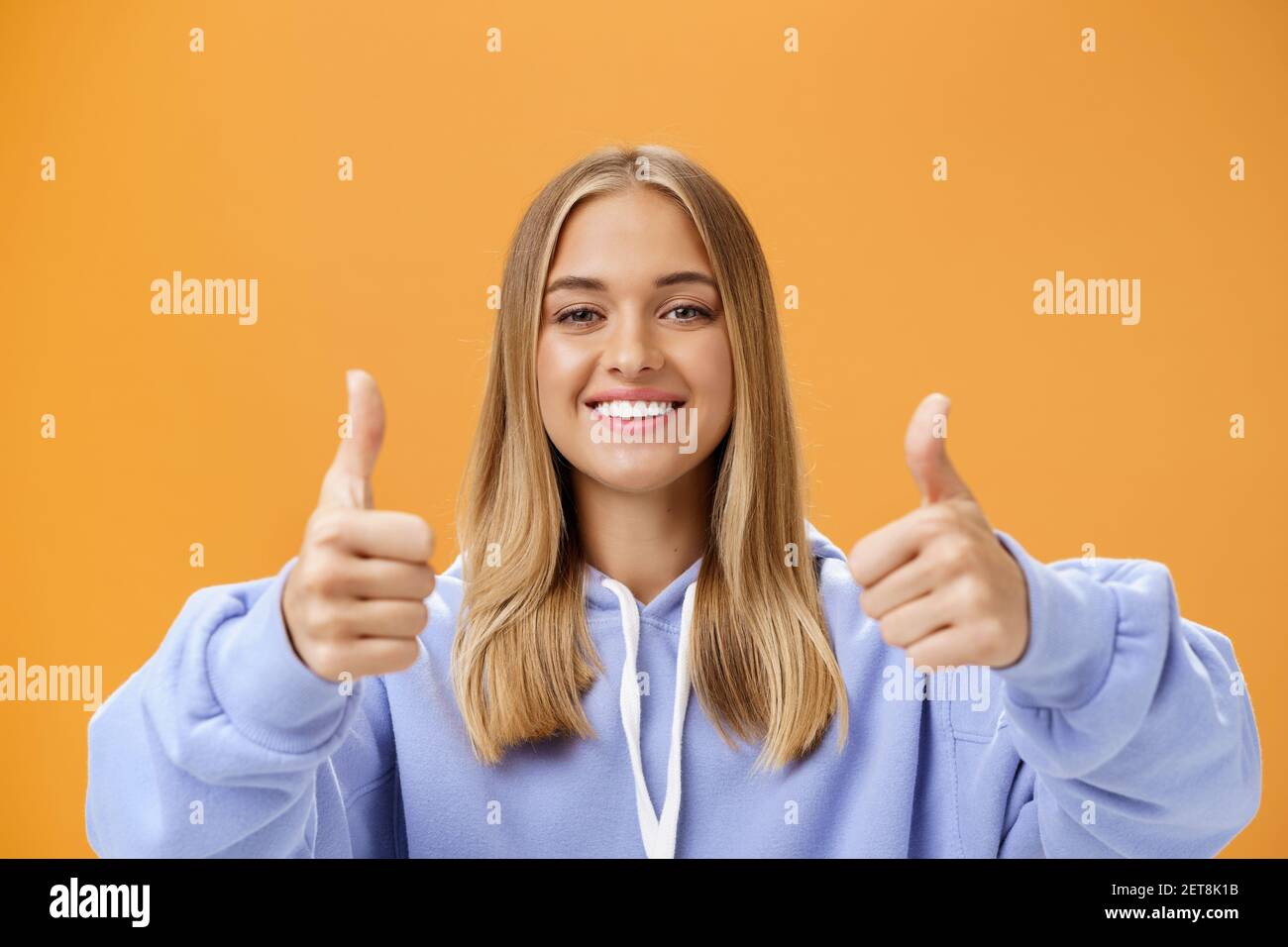 Portrait of happy optimistic woman showing thumbs up gesture and ...