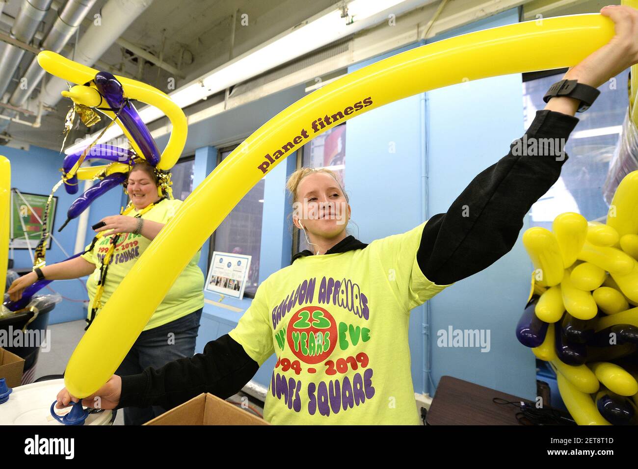 Volunteers inflate some of the 25,000 balloon clappers that will be ...