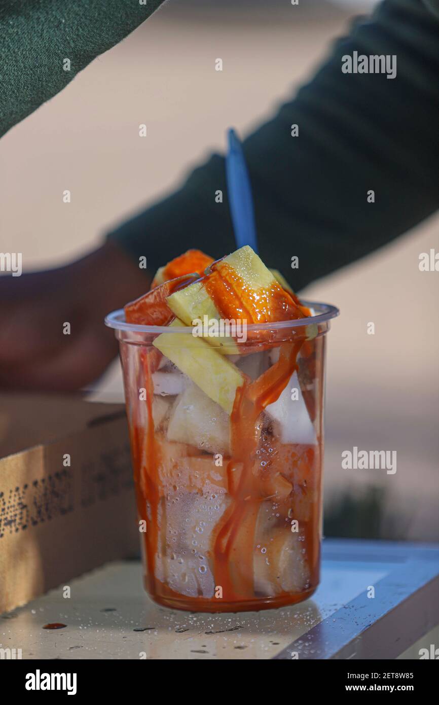 Pasctic glass with chopped fruit known as Pico de Gallo in Naco is a ...