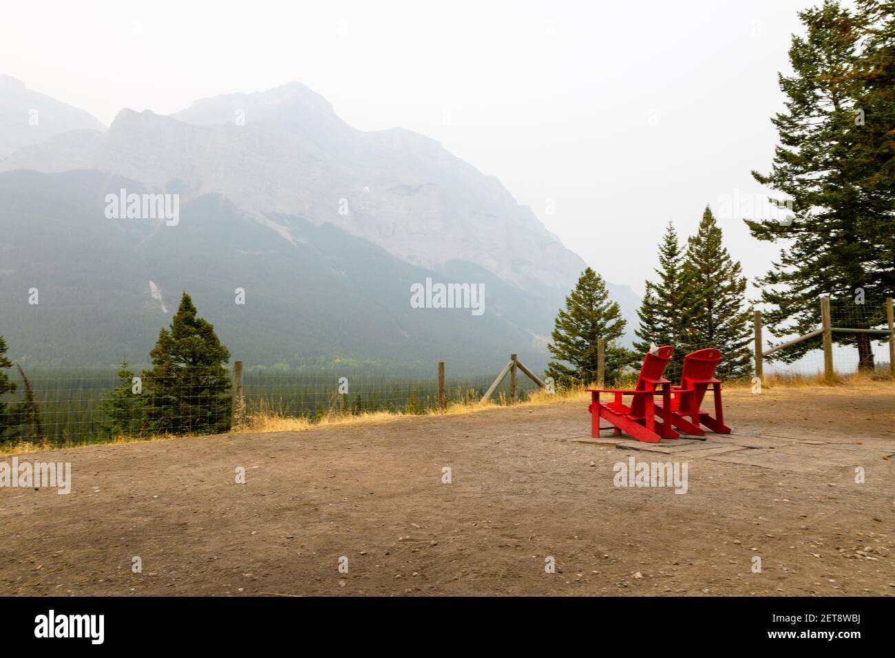 red Adirondack chairs in Banff National Park, Canada with cloudy ...