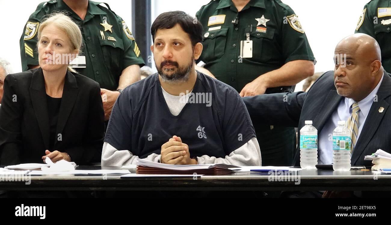 Nouman Raja sits with members of his defense team during his sentencing ...