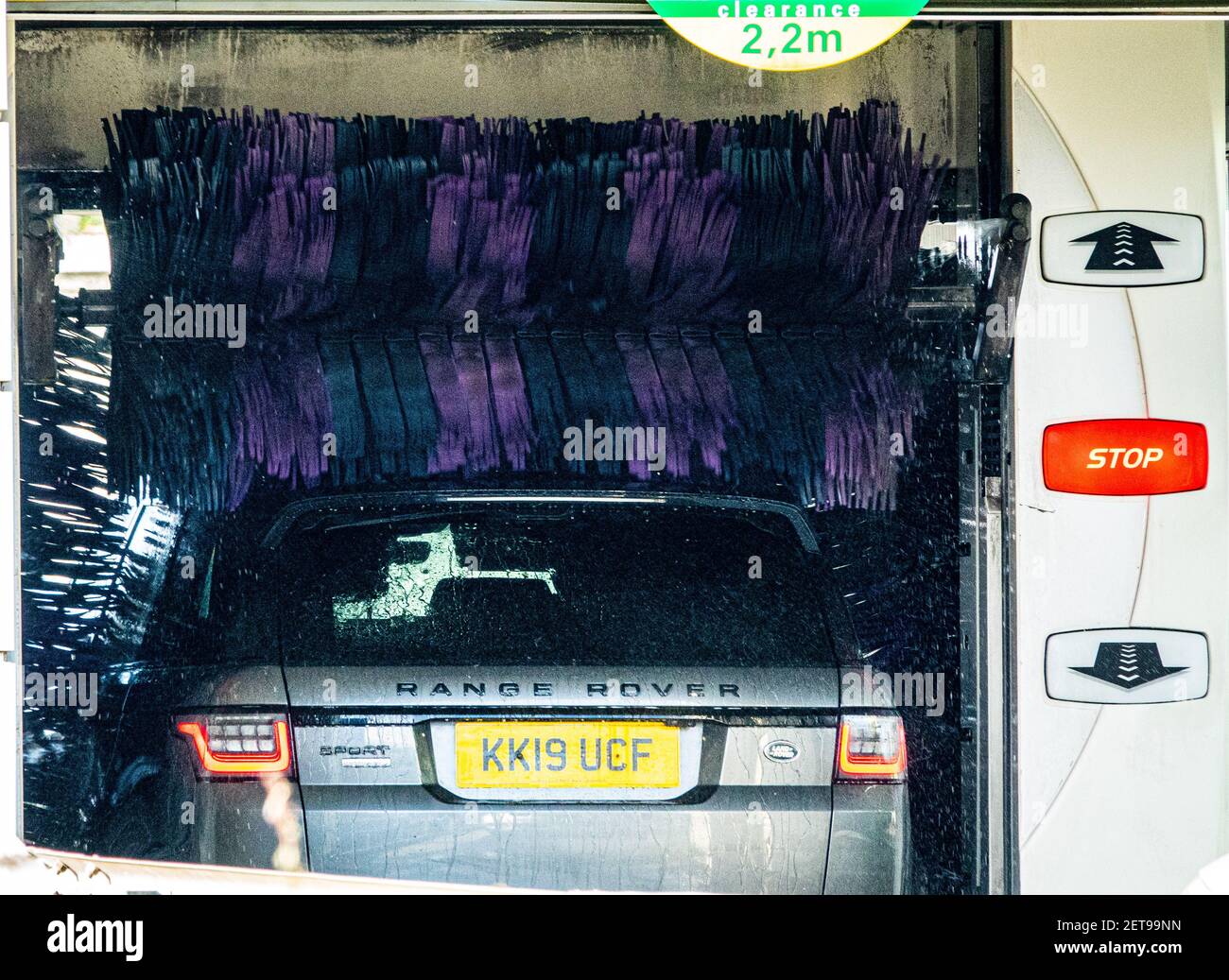 A car (silver Range Rover) being washed in an automated machine jet car ...