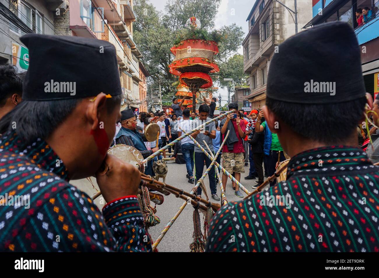 Devotees play the traditional instruments during a chariot procession ...
