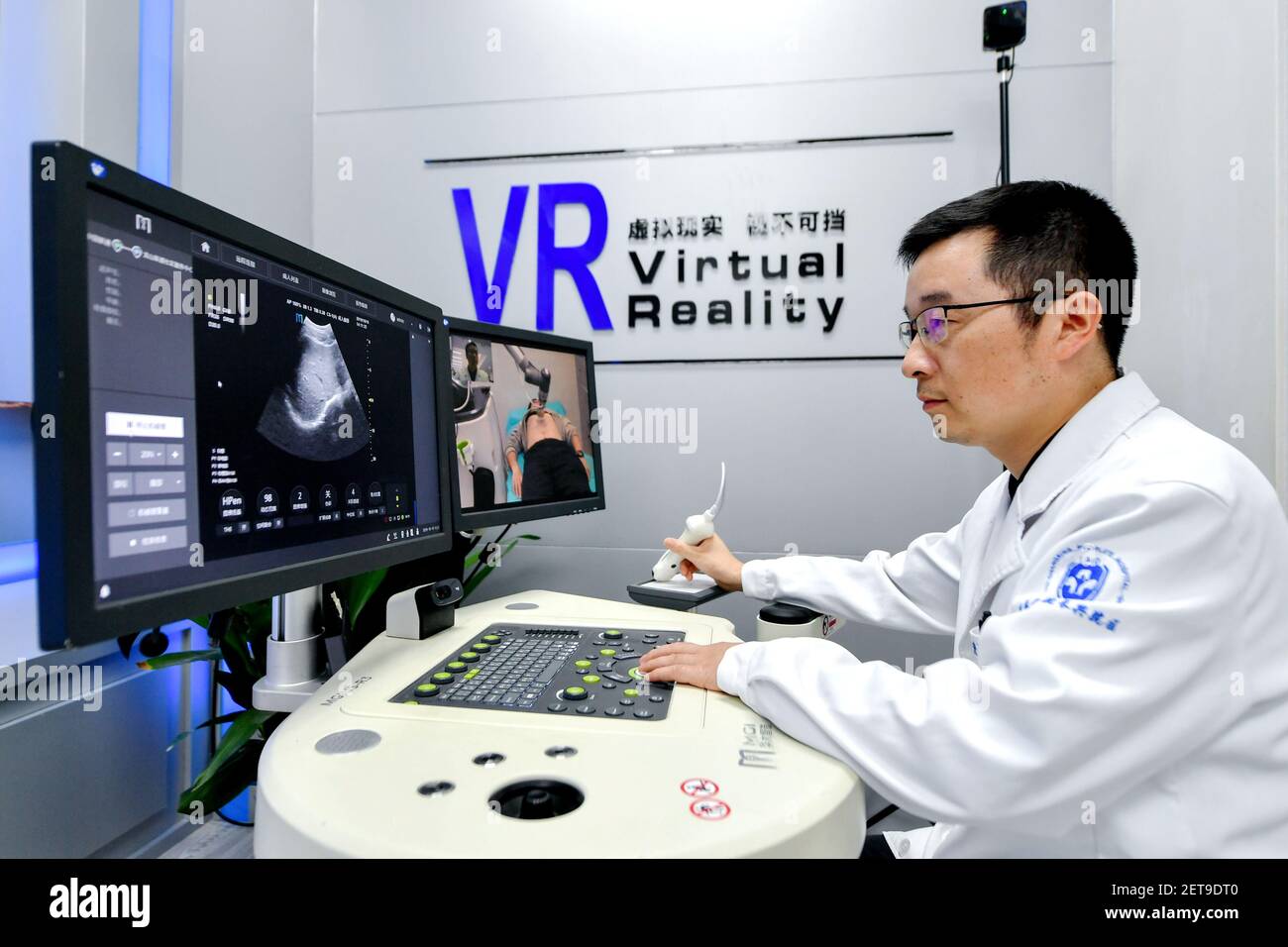 A doctor is doing B-ultrasound for a patient using 5G technology at the ...