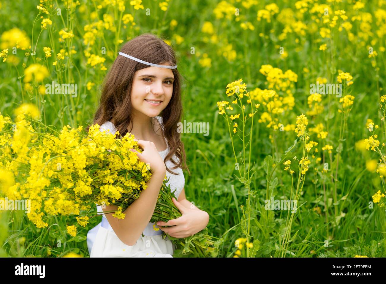 A child in a blooming field with yellow flowers Stock Photo - Alamy