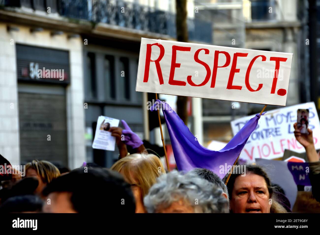 A woman holds a placard that says respect during the demonstration ...
