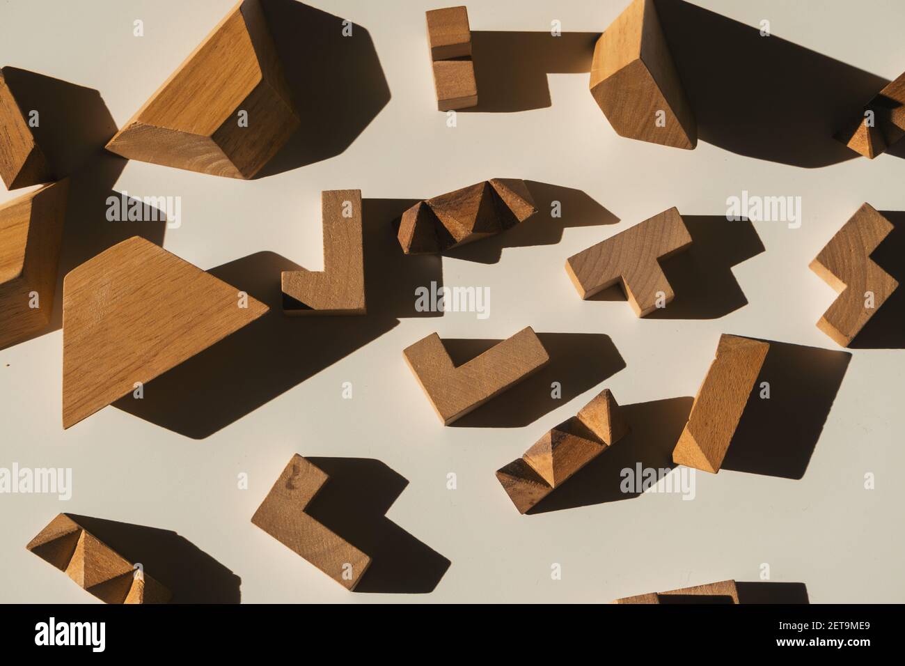 A top view of wooden block puzzle pieces on a white table Stock Photo ...
