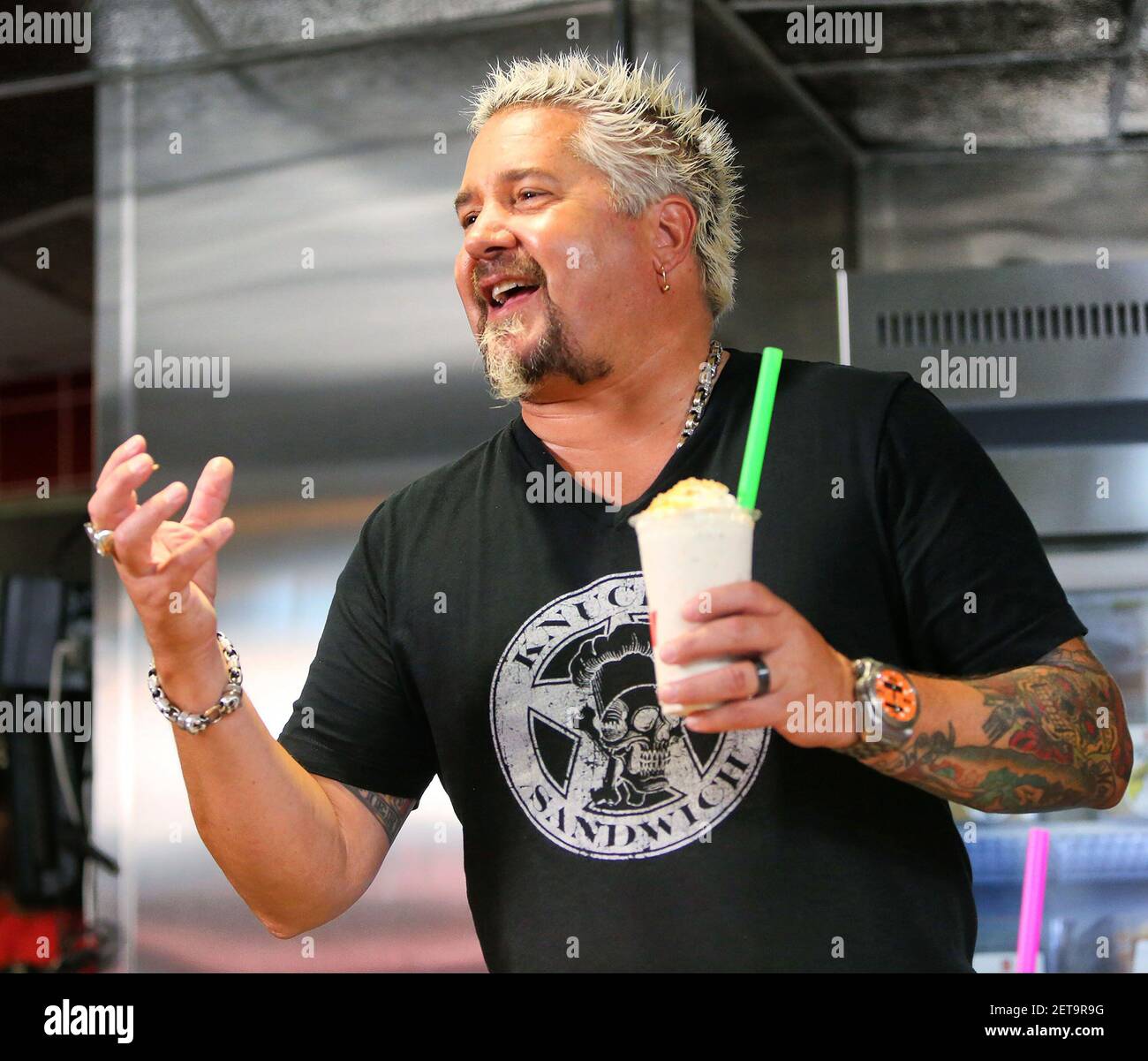 Celebrity chef Guy Fieri talks about his dishes while filming at ...