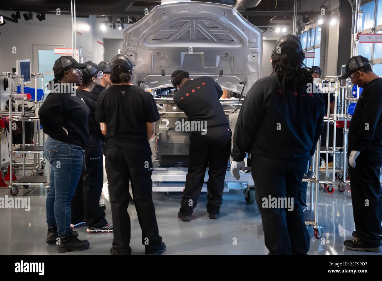 New Tesla employees are taught their task on assembling a car on March ...