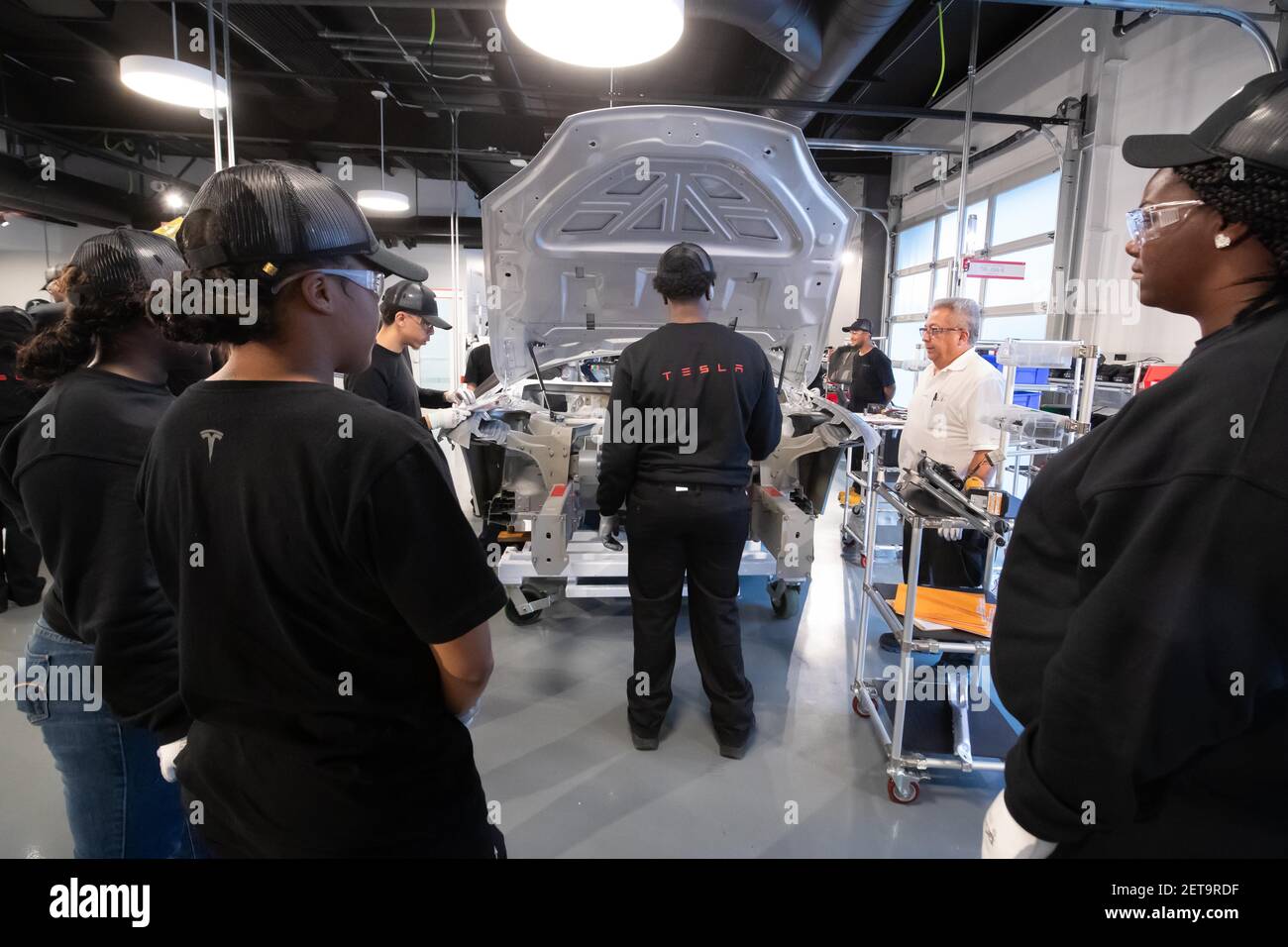 New Tesla employees are taught their task on assembling a car on March ...