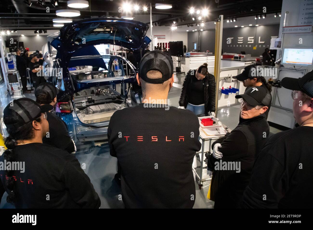 New Tesla employees are taught their task on assembling a car on March ...