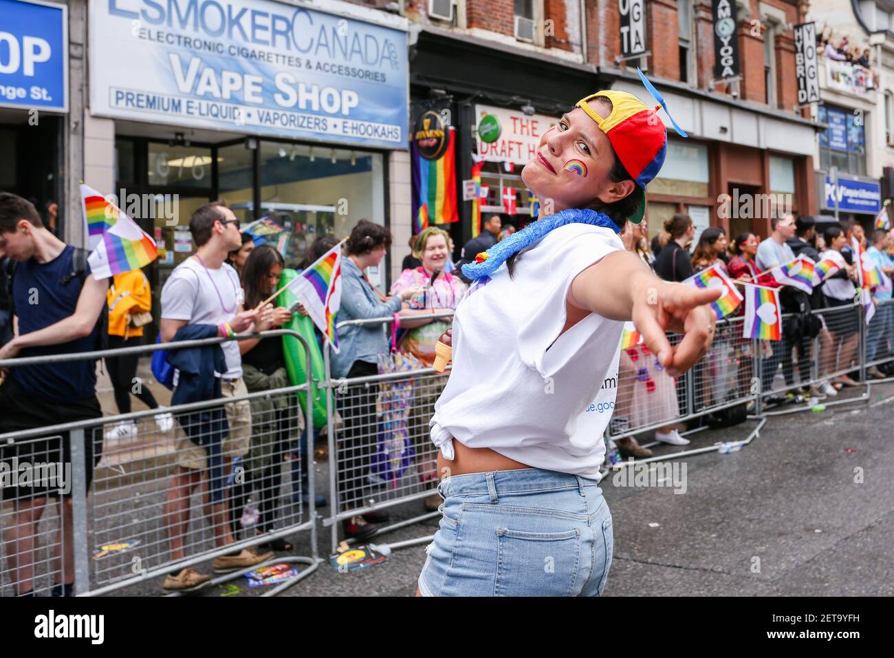 Participant turning as she poses for a photo during the Toronto LGBTQ ...