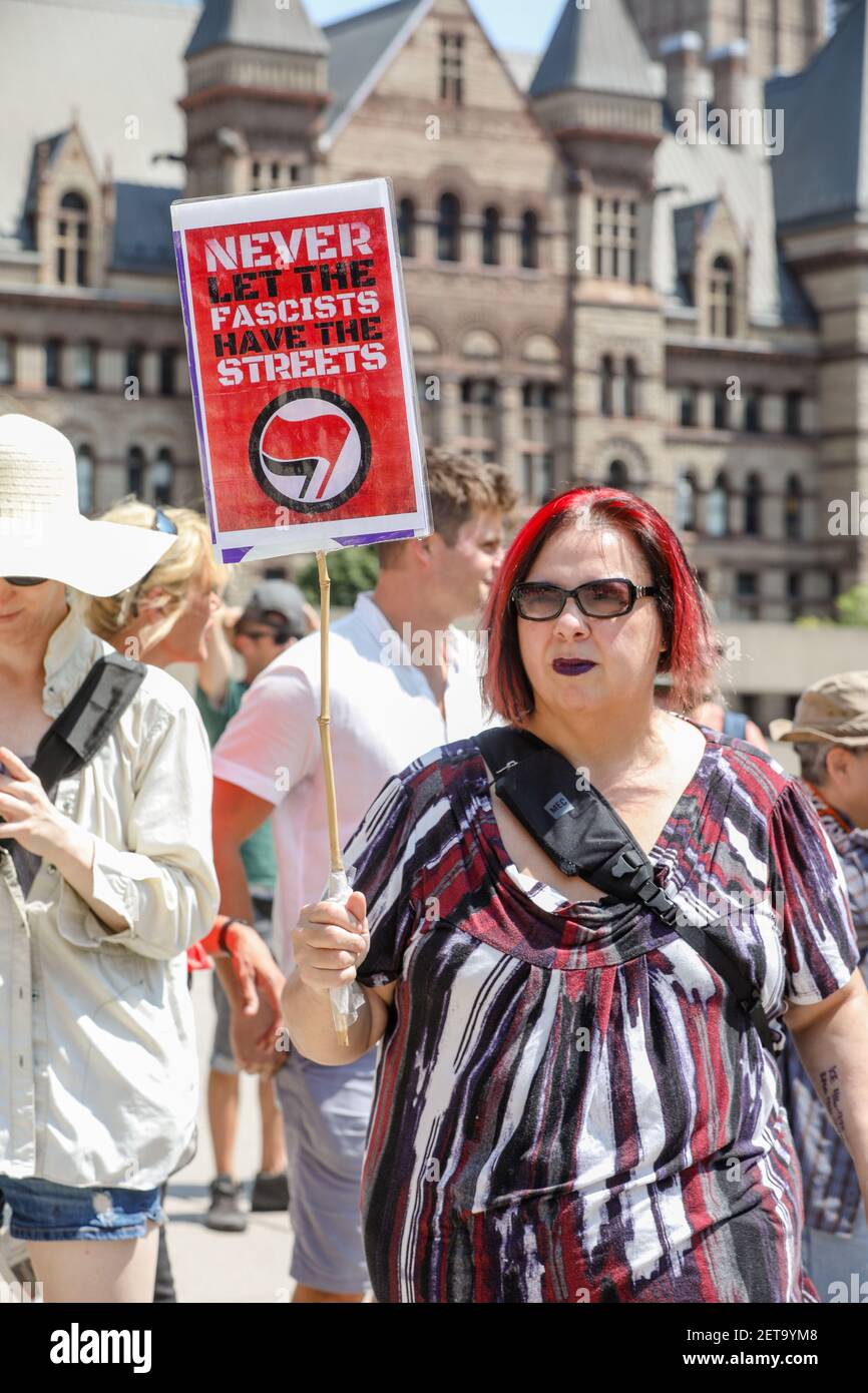 A protester holding a placard saying, never let the fascists have the ...