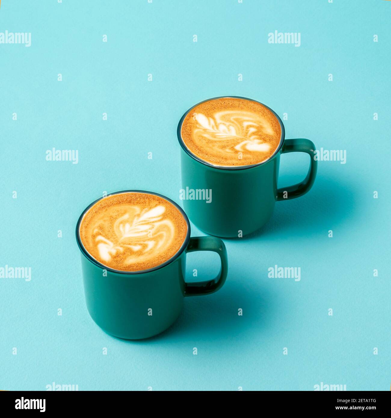Flat lay latte art coffee in green cups on green background., copy ...