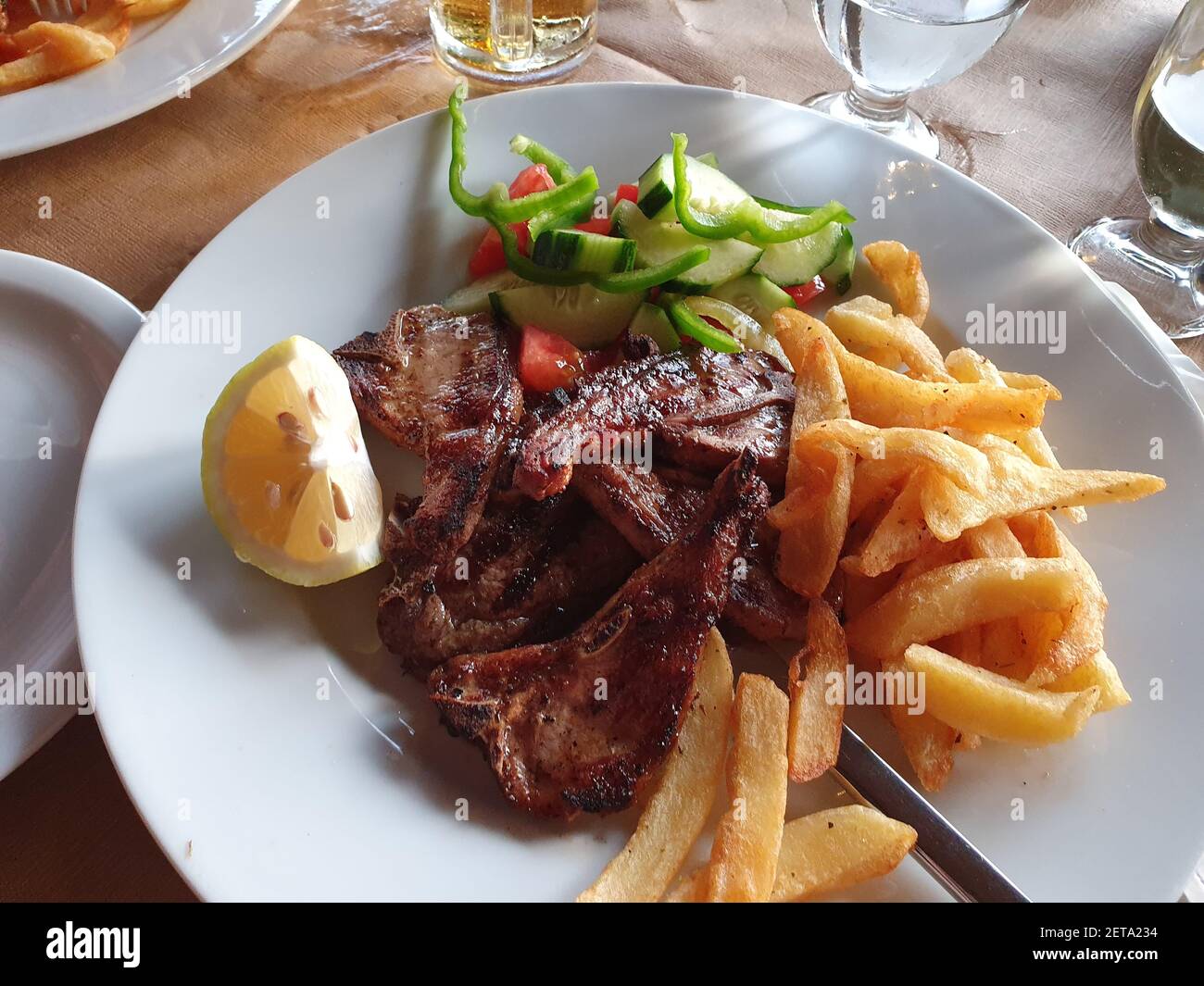 The appetizing lamb chops with french fries and fresh salad Stock Photo ...