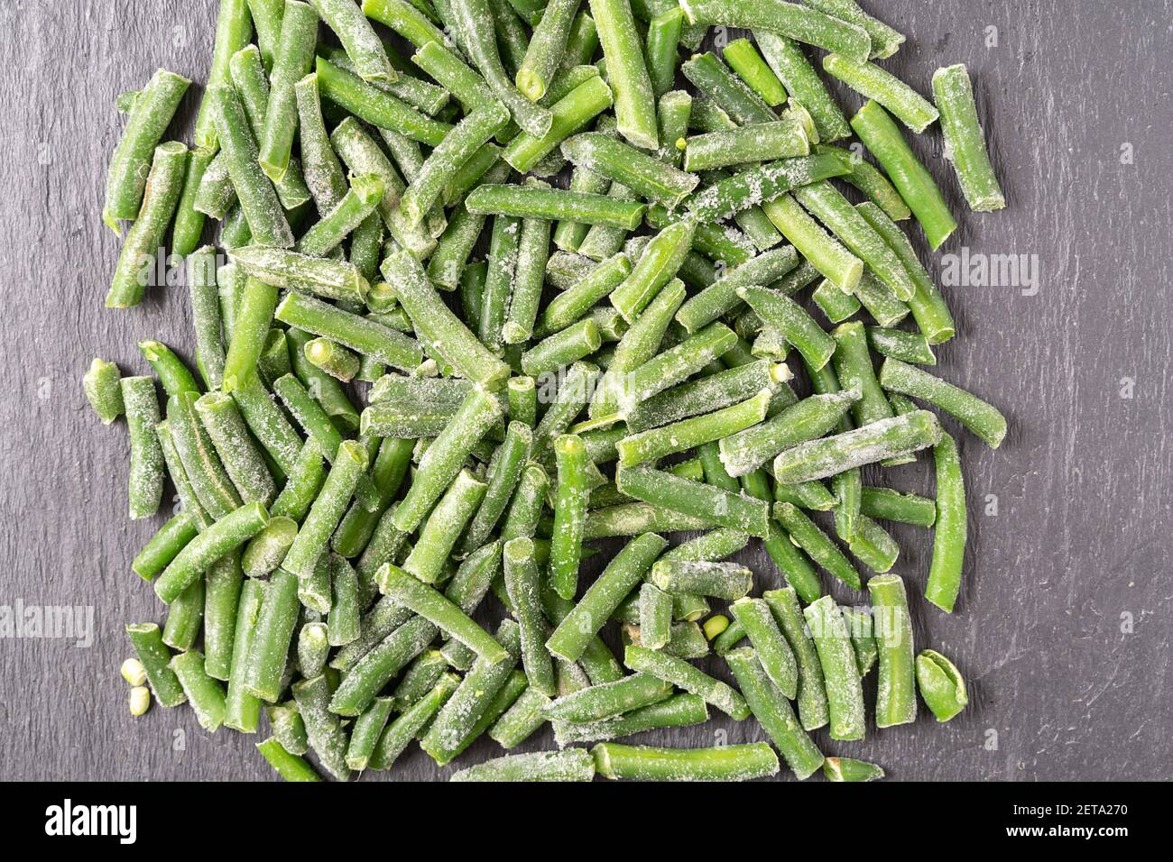 Frozen green string beans on black background, flat lay Stock Photo - Alamy