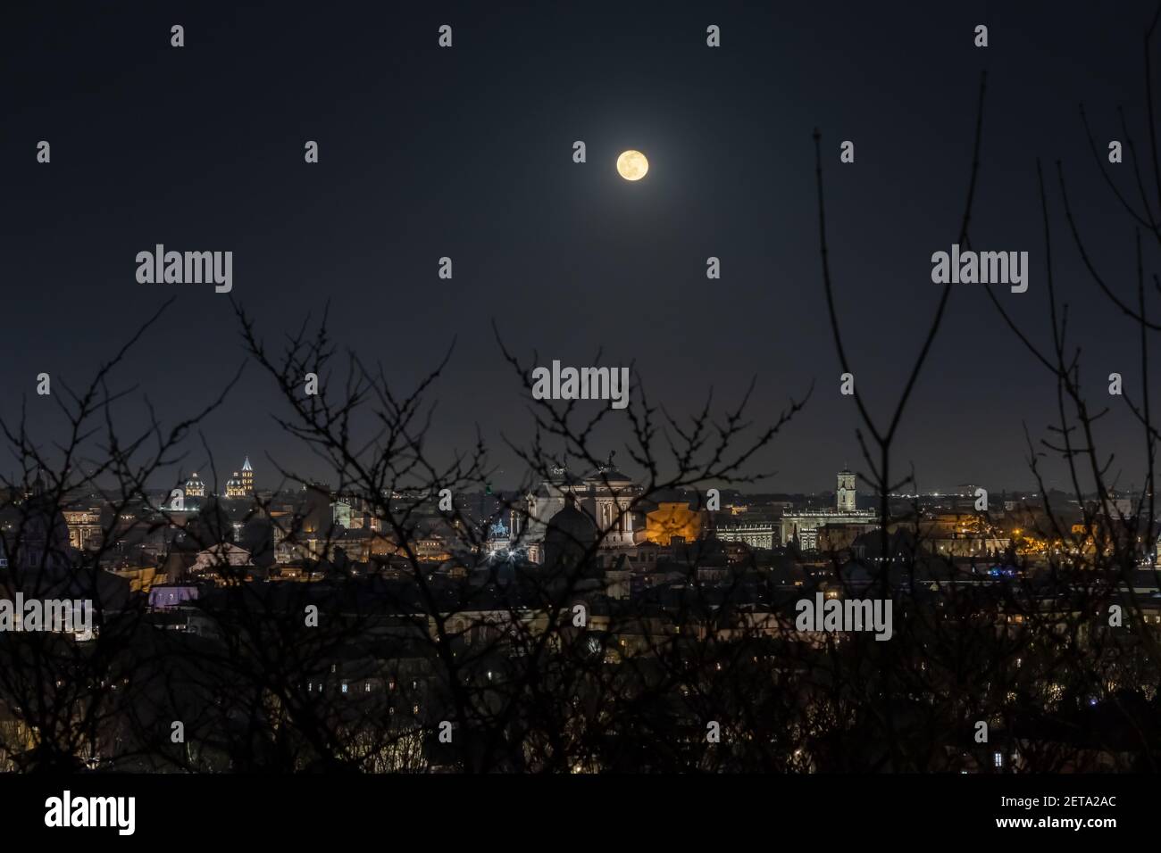 Rome city skyline at night with full moon Stock Photo - Alamy
