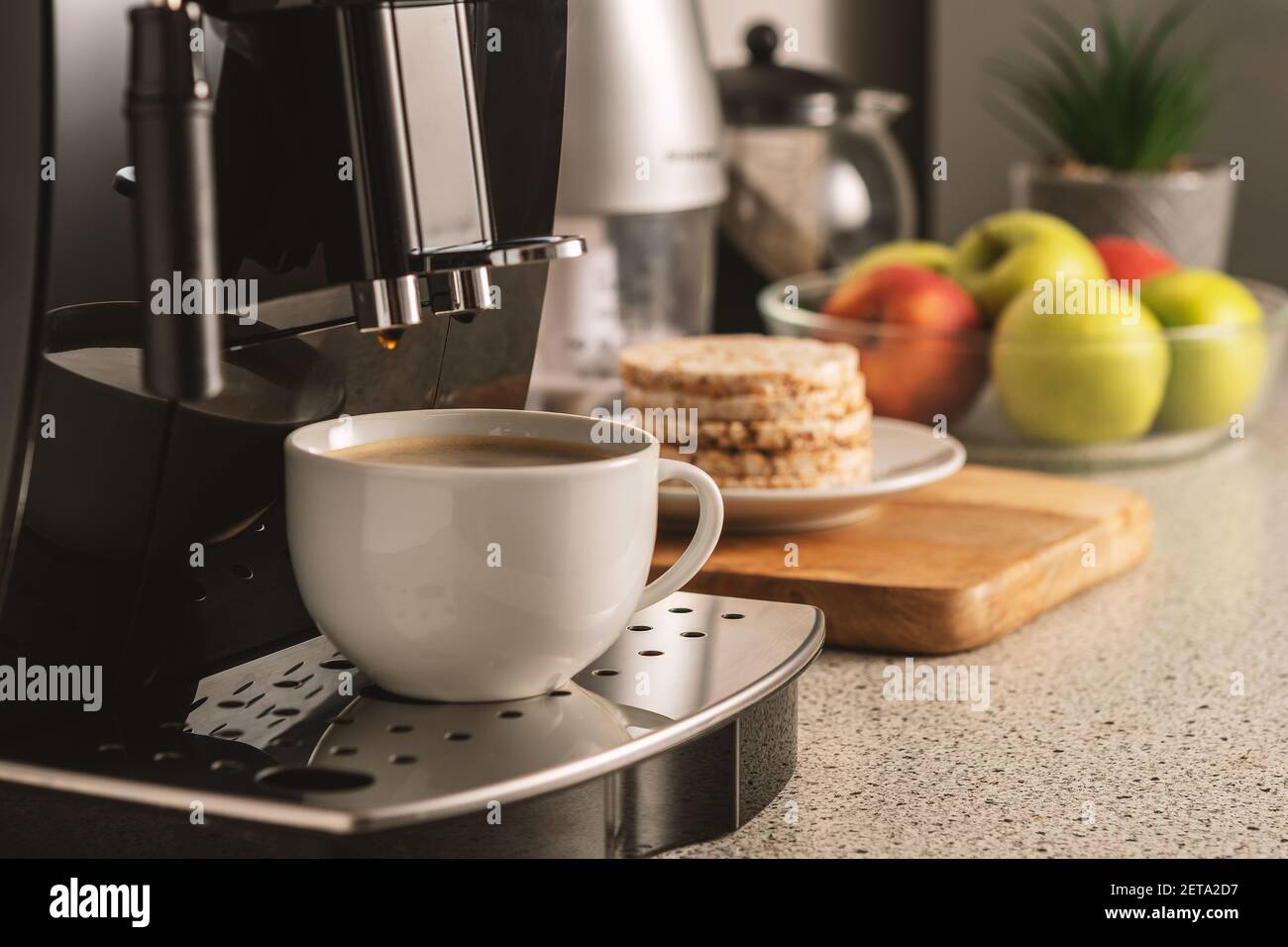 Modern espresso coffee machine with a cup in interior of kitchen ...