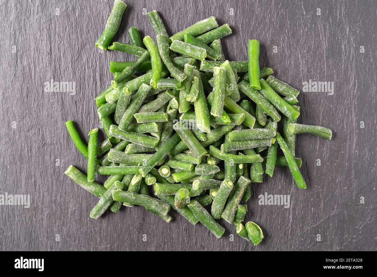 Frozen green string beans on black background, flat lay Stock Photo - Alamy