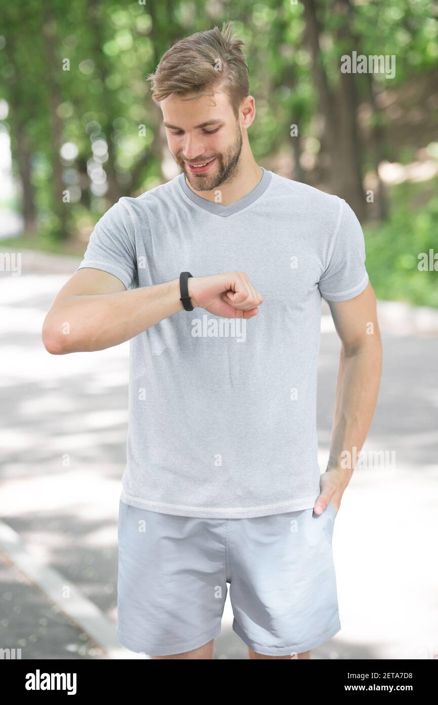 Best for training. Sportsman tracking his training with a sports watch ...