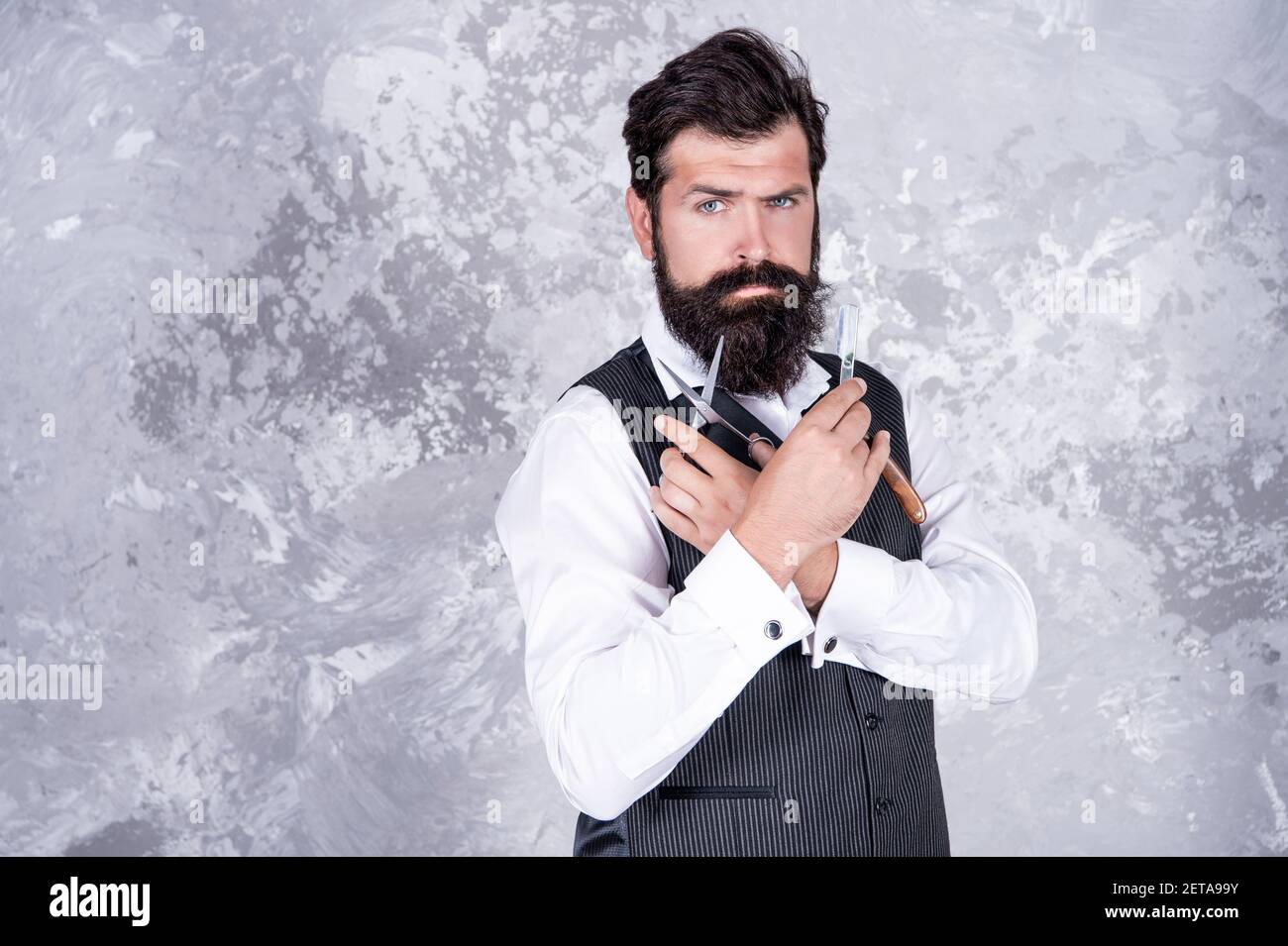 handsome brutal man barber with beard and moustache hold barbershop ...