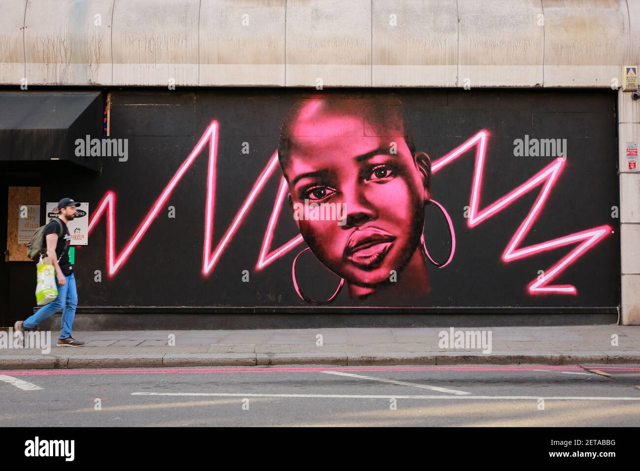London, UK. 27 Feb 2021. Neon style graffiti of a woman by artist David ...