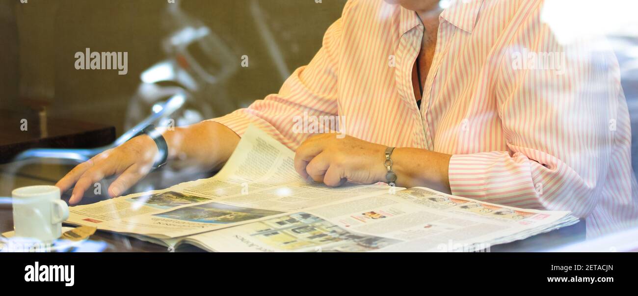 Female pensioner reading newspaper through hi-res stock photography and ...