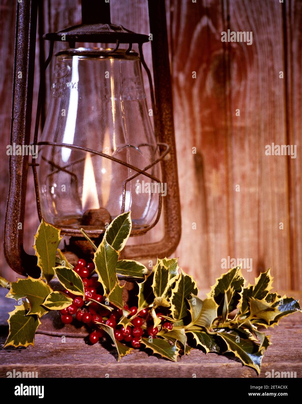 1970s ANTIQUE LANTERN WITH FLAME LIT ON WOOD BACKGROUND WITH SPRIG OF ...