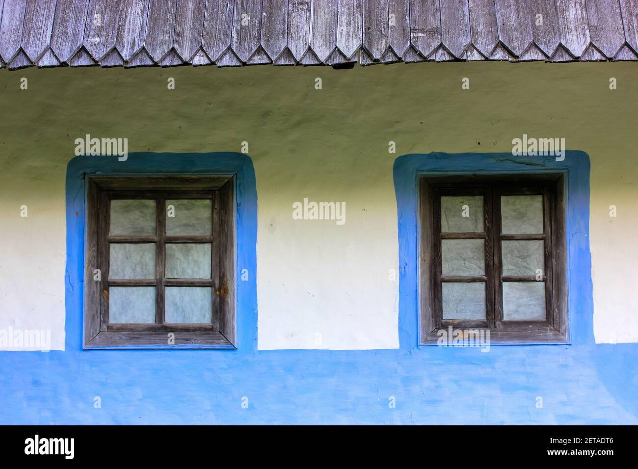 The facade of an old clay blue and white house in the Ukrainian style ...