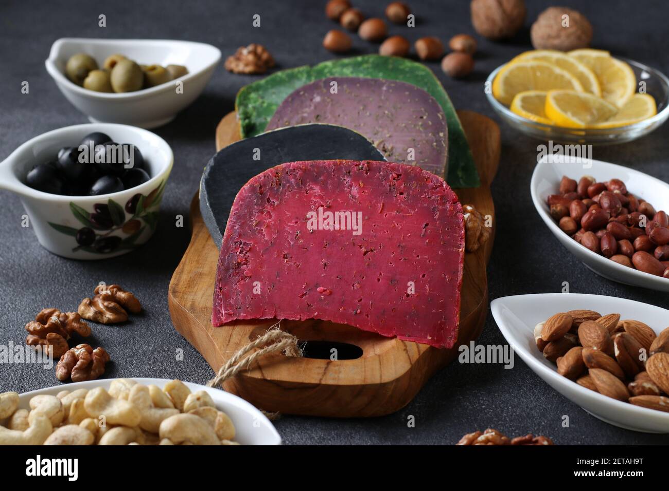 Multi colored gourmet cheese, olives, nuts and sliced lemon. Wine party ...