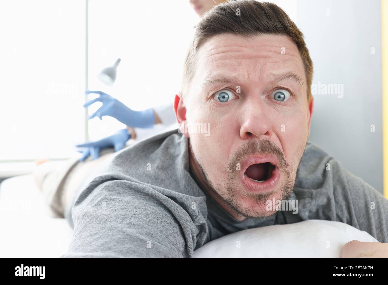Doctor gives an injection to frightened man Stock Photo - Alamy