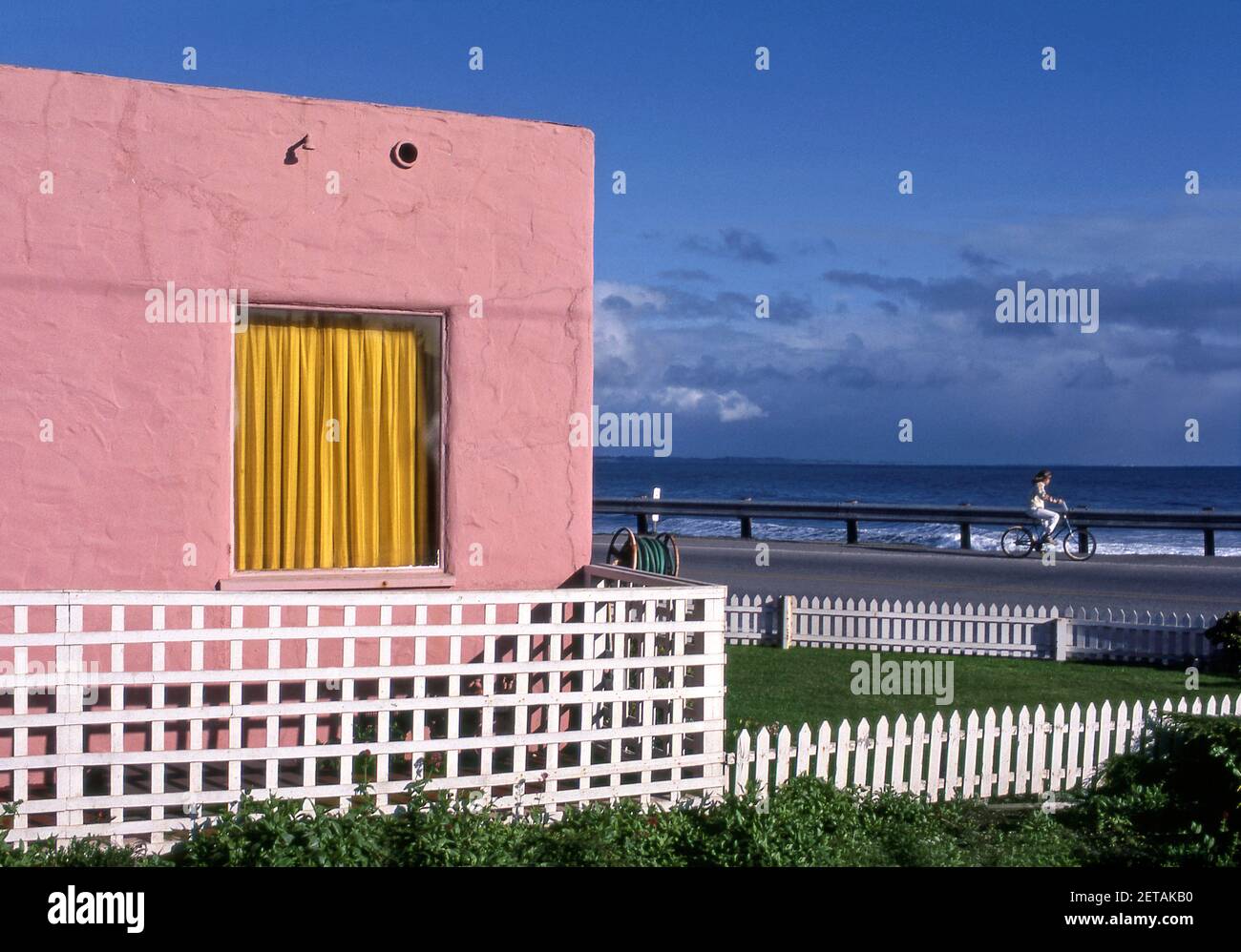 House with pink stucco exterior near the ocean on the California coast ...