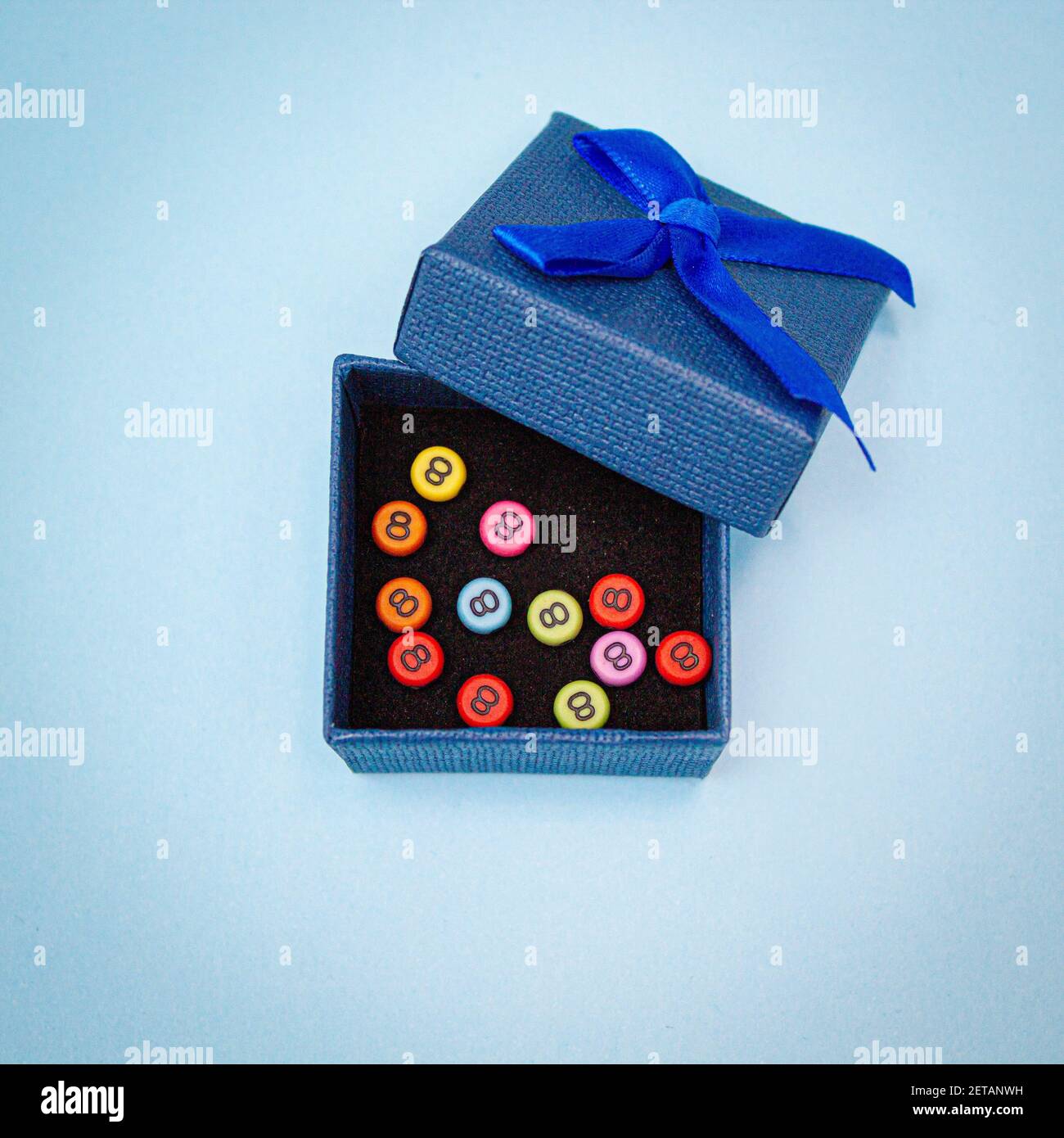 Blue gift box with numbers 8 in it on blue background. International ...