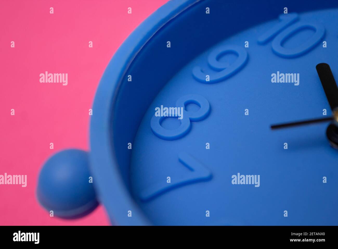 Number 8 shown on a blue clock on a pink background Stock Photo - Alamy