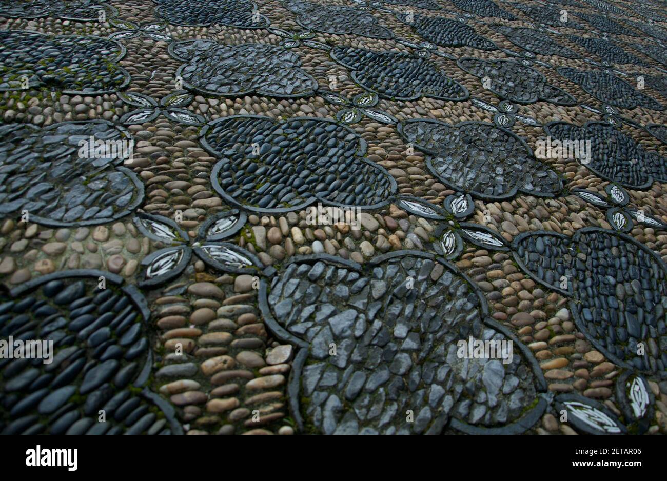 a pebbled surface with black and yellow patterns Stock Photo - Alamy