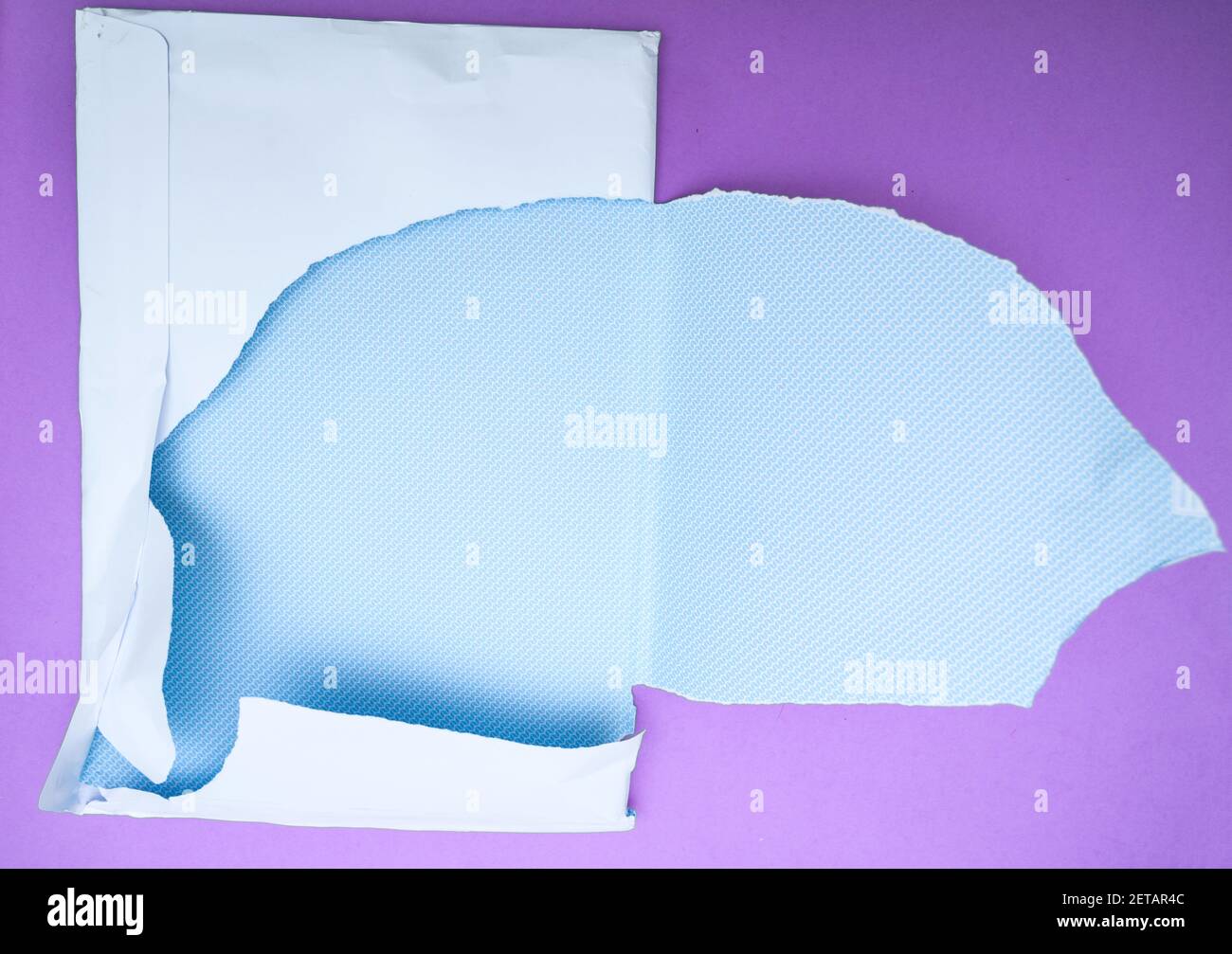 Opened damaged destroyed postal envelope isolated on violet background ...