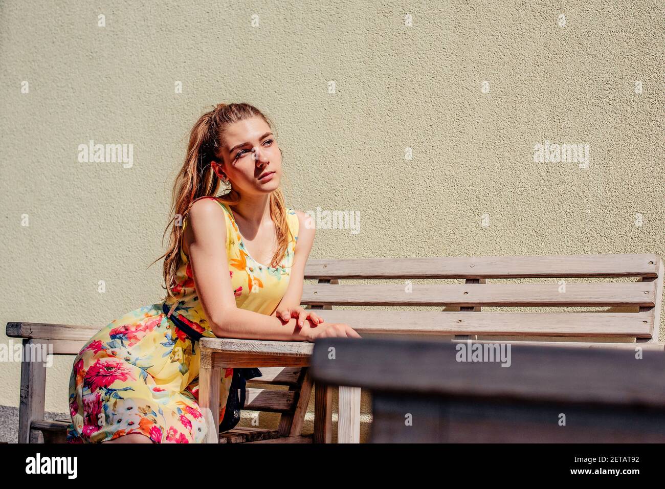 girl in dress walks through the old town in the summer. Beautiful ...