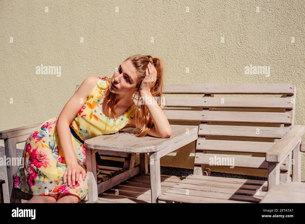 girl in dress walks through the old town in the summer. Beautiful ...