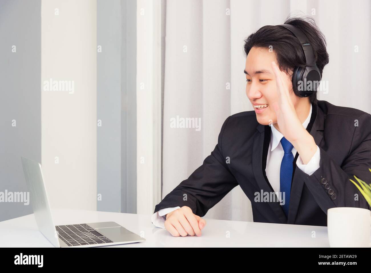 Work from home, Asian young businessman smile wearing headphones and ...