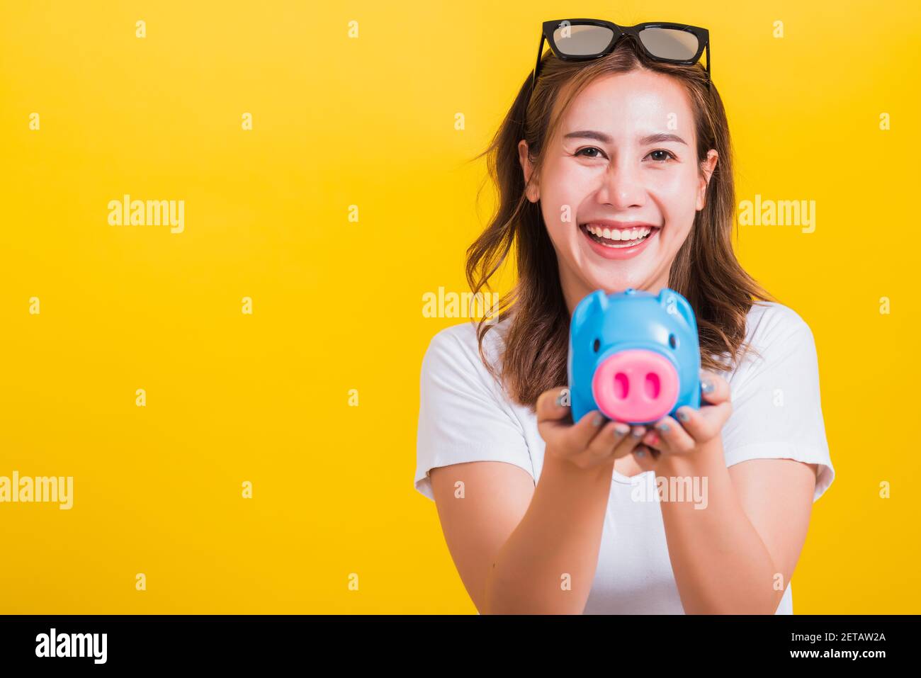 Portrait Asian Thai beautiful happy young woman smiling hold piggy bank ...