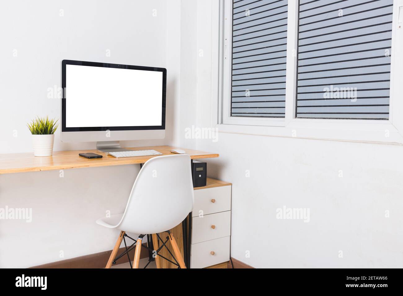 Computer monitor with white blank screen on the business desk with ...