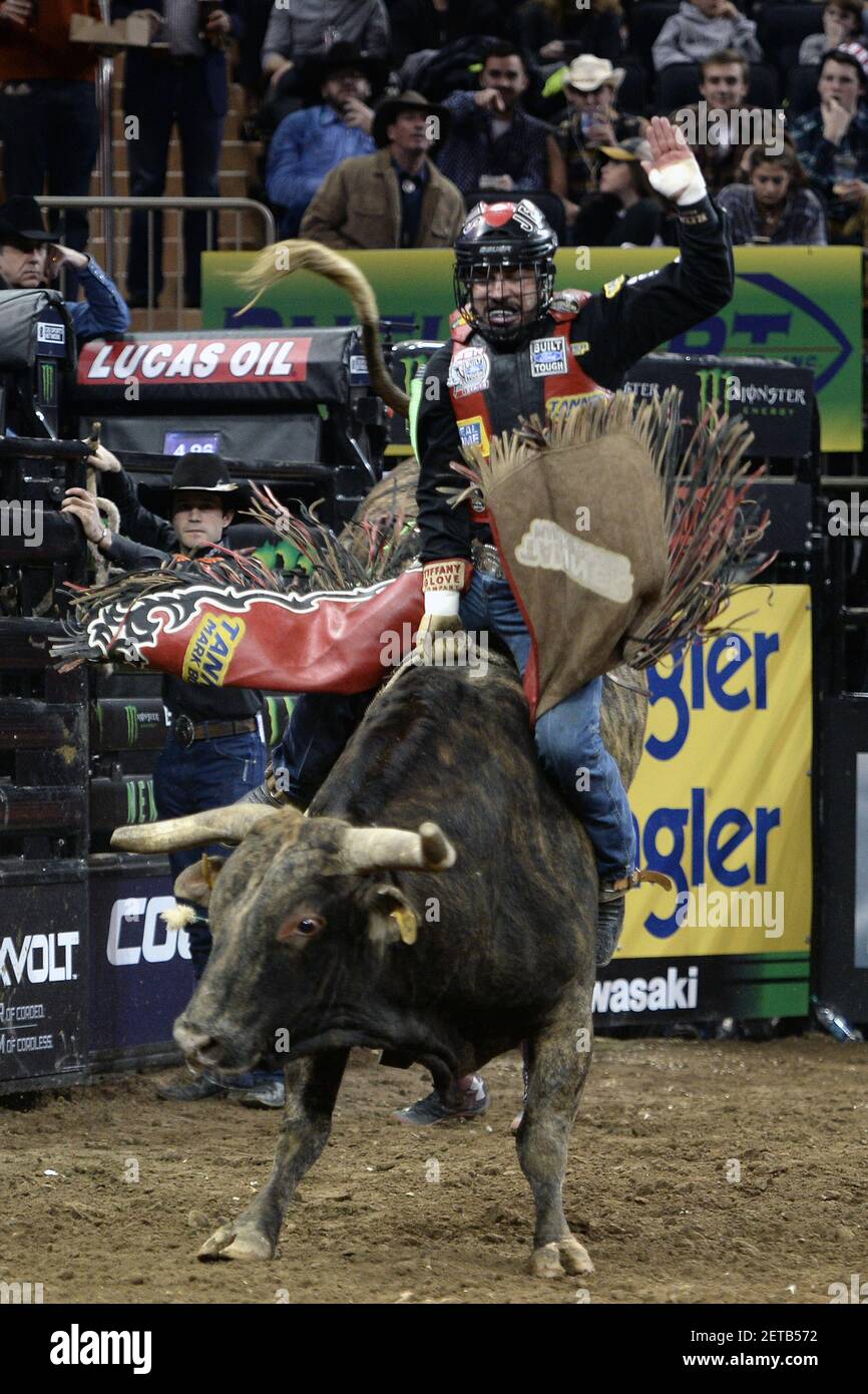 Alex Cardozo rides a bull named Ace during the first round of the ...